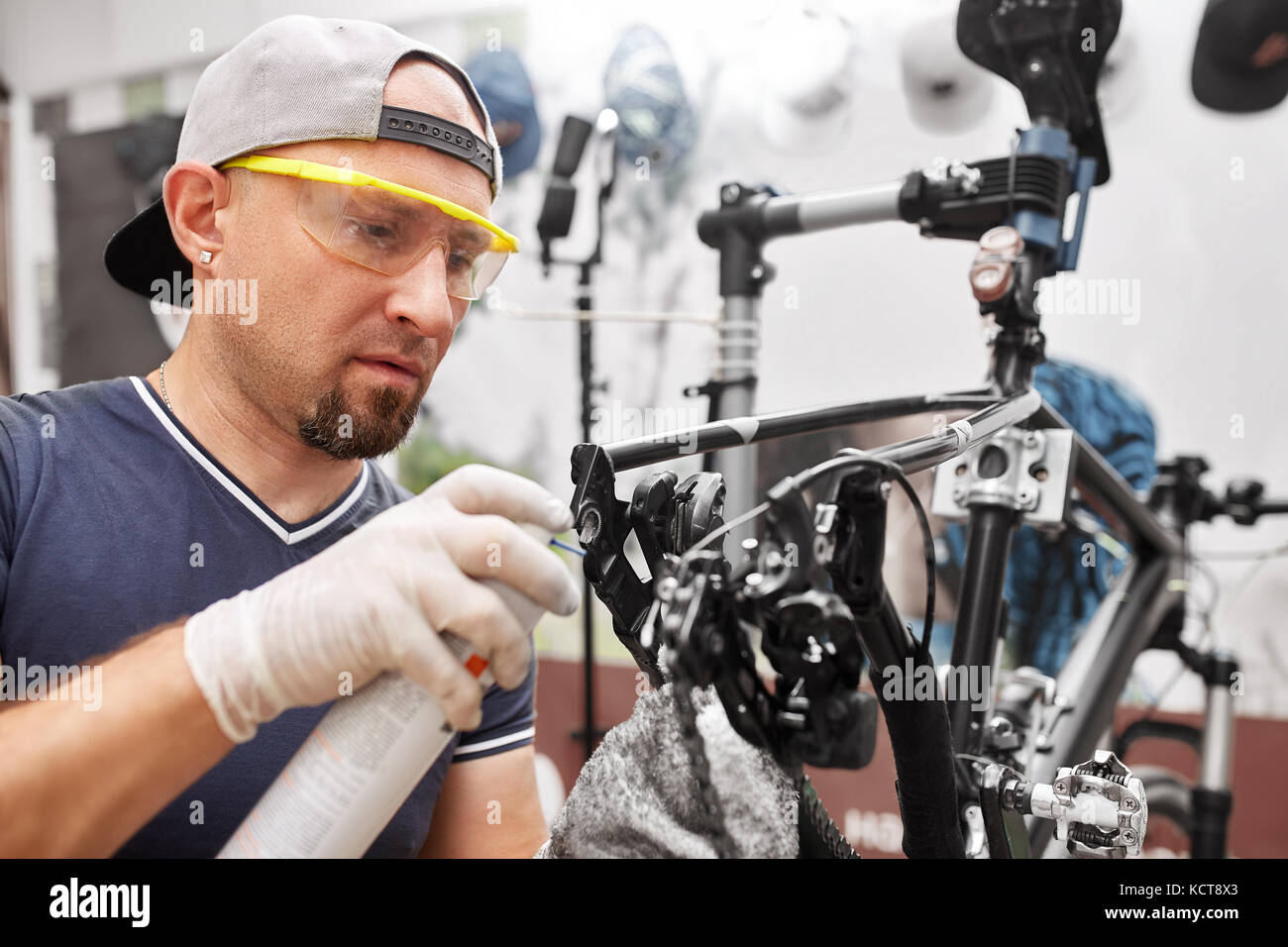 Mechanic repairing bicycle in his workshop. Bicycle service Stock Photo ...