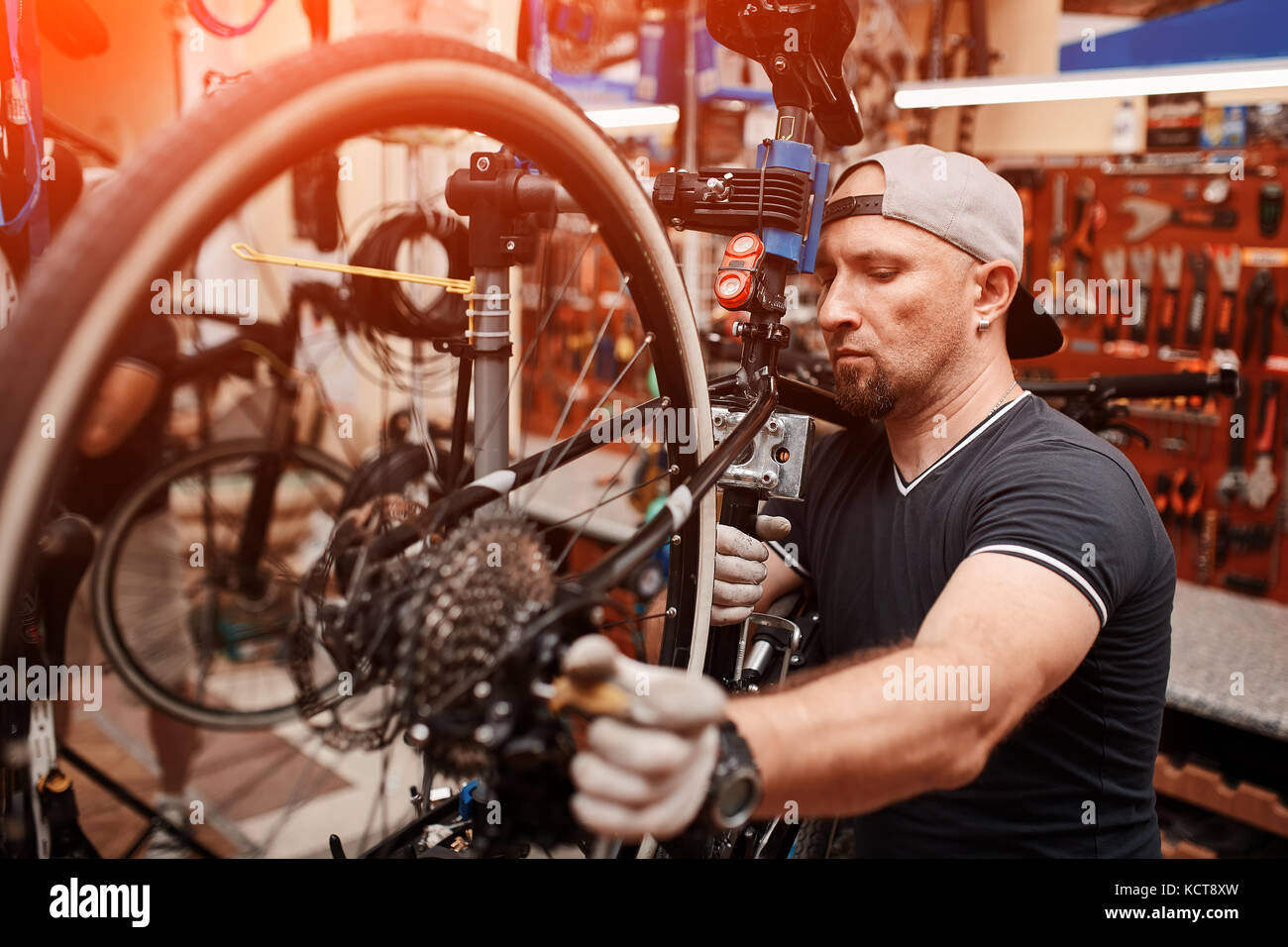 Man with bike in bikeshop hi-res stock photography and images - Alamy