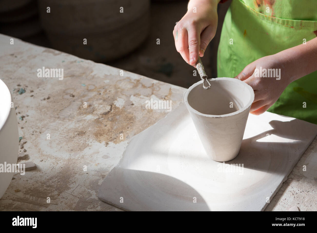 Mid-section of female pottery shaping a pot in pottery workshop Stock ...
