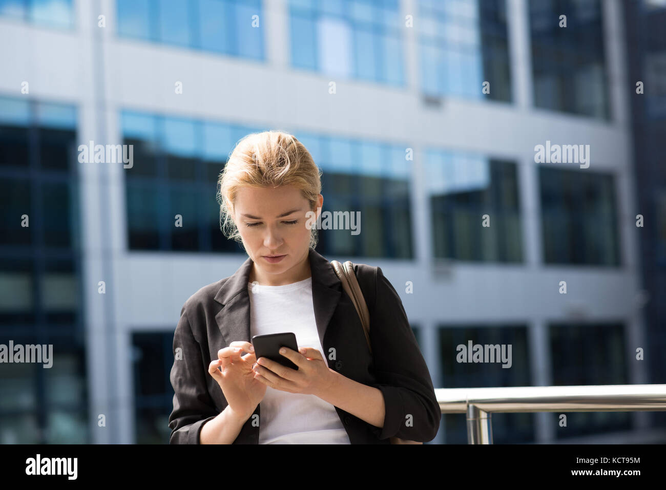 University student using mobile phone in campus at college Stock Photo ...