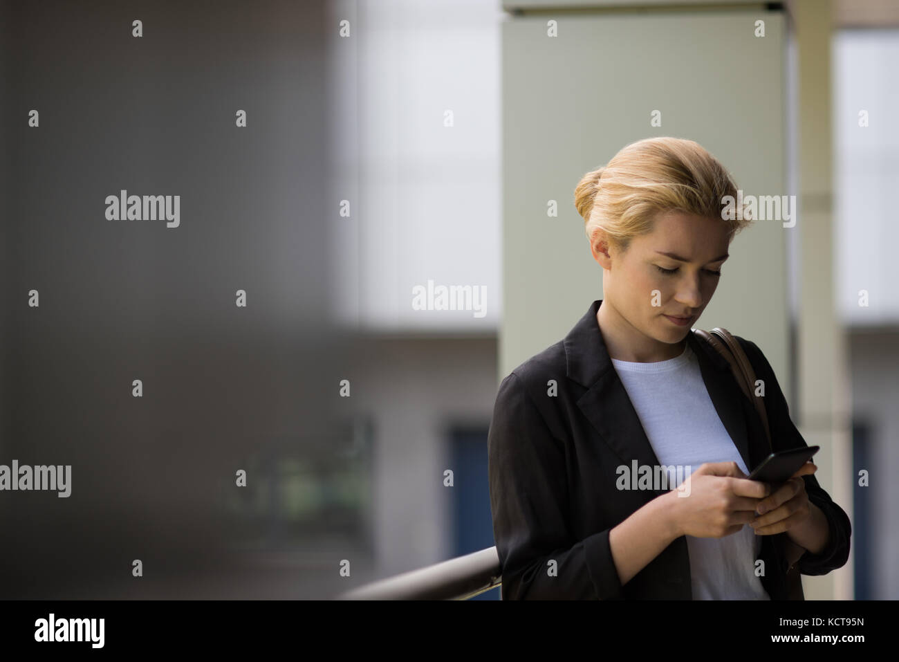 University student using mobile phone in campus at college Stock Photo ...