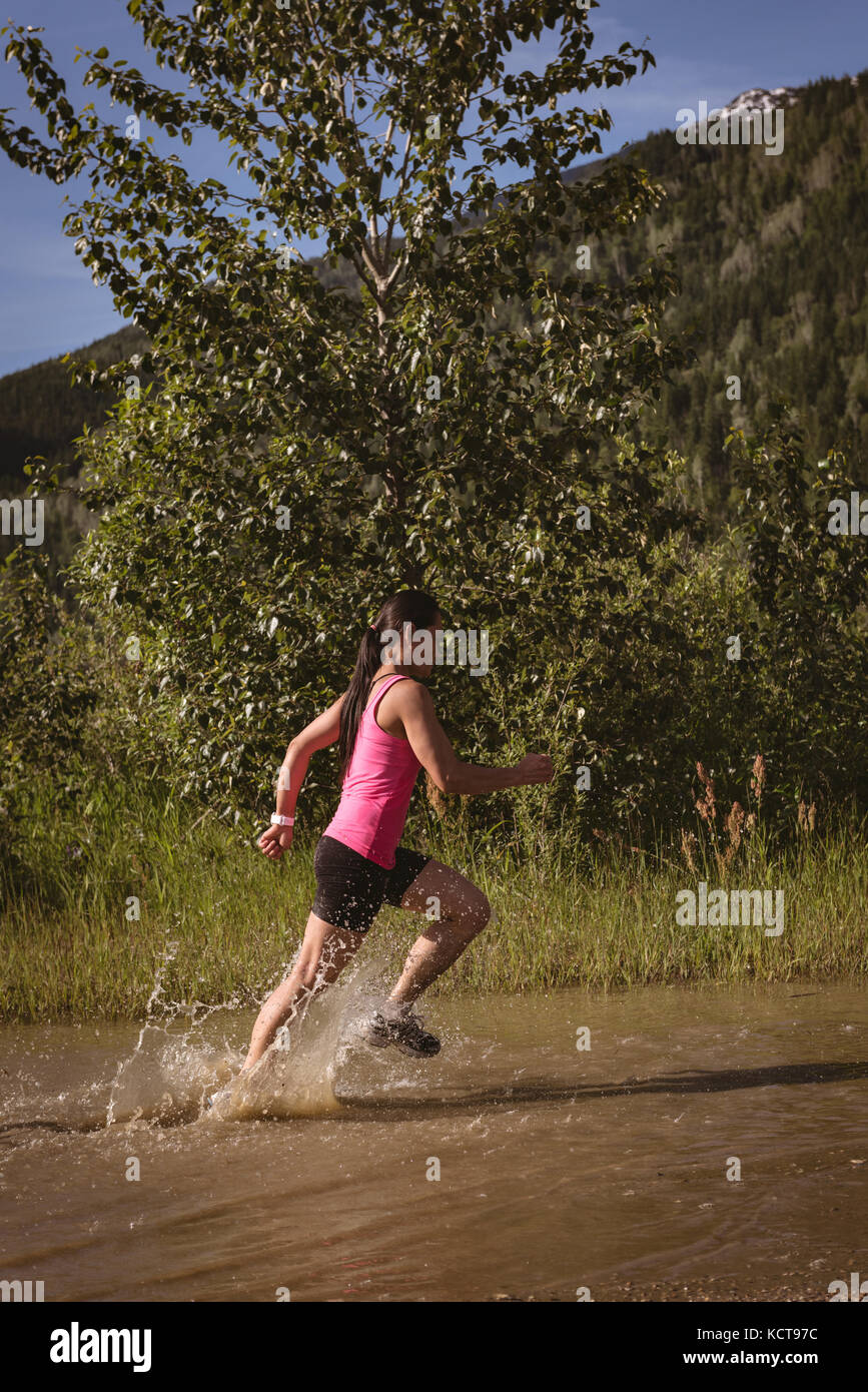 Fit woman jogging in water on a sunny day Stock Photo - Alamy