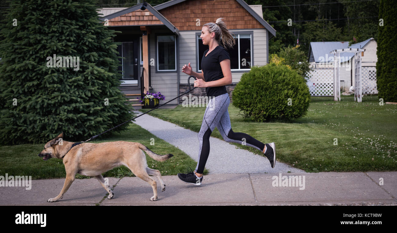 Woman jogging with dog hi-res stock photography and images - Alamy