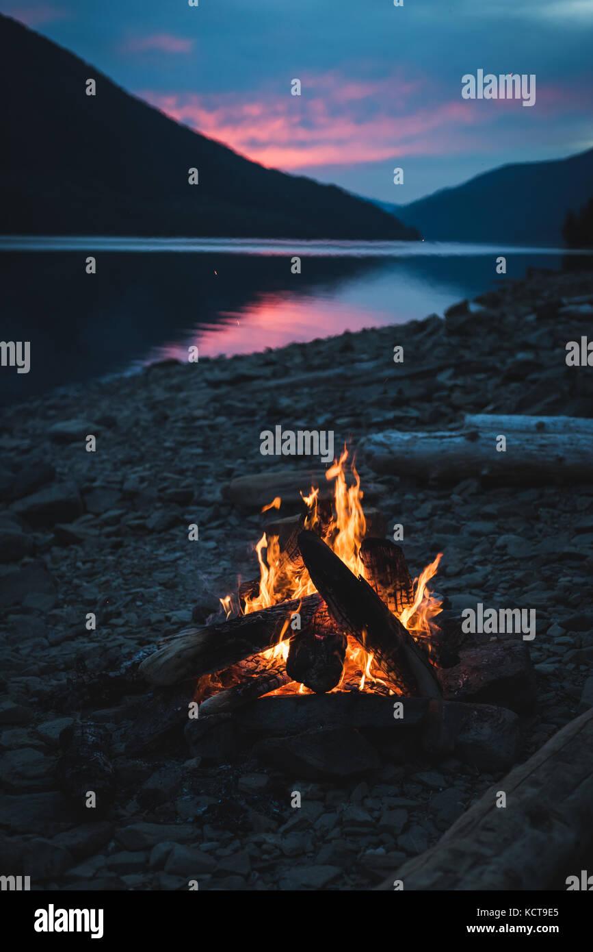 Campfire near lakeside at night Stock Photo - Alamy