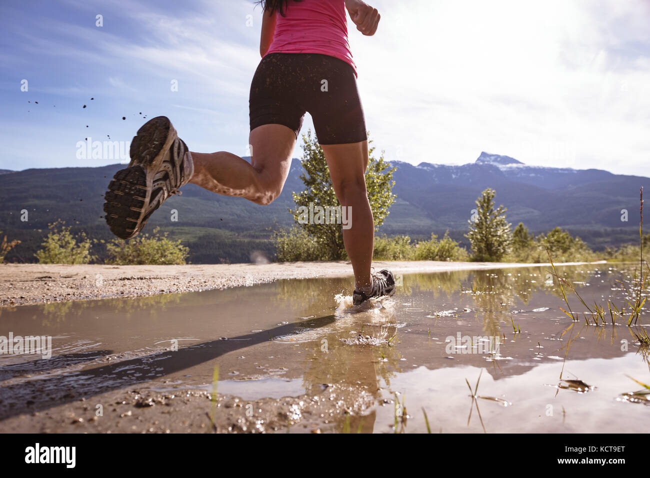 Fit woman jogging in water on a sunny day Stock Photo - Alamy