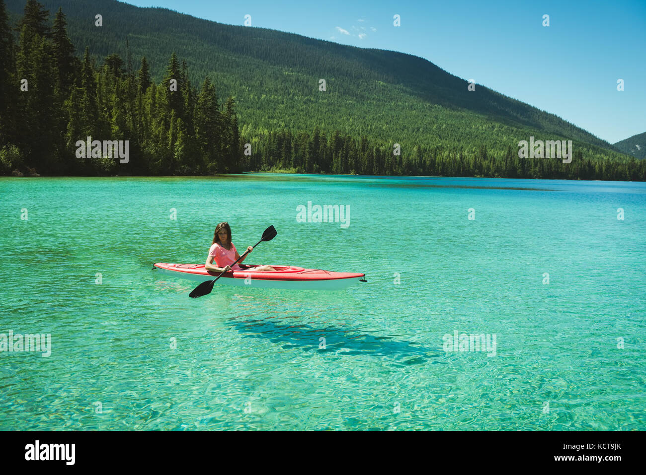 Woman kayaking in river on a sunny day Stock Photo - Alamy