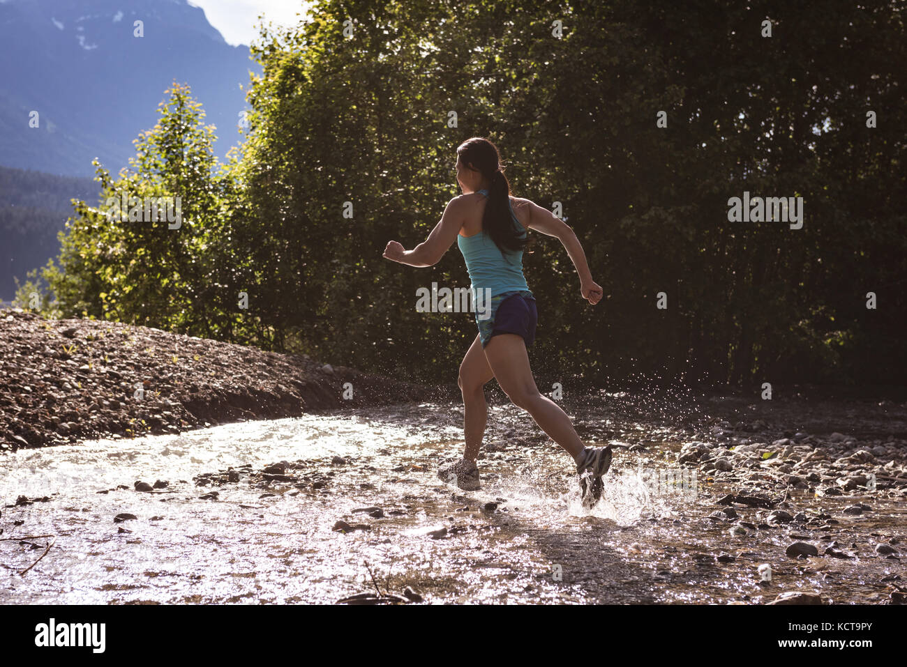 Fit woman jogging in water on a sunny day Stock Photo - Alamy