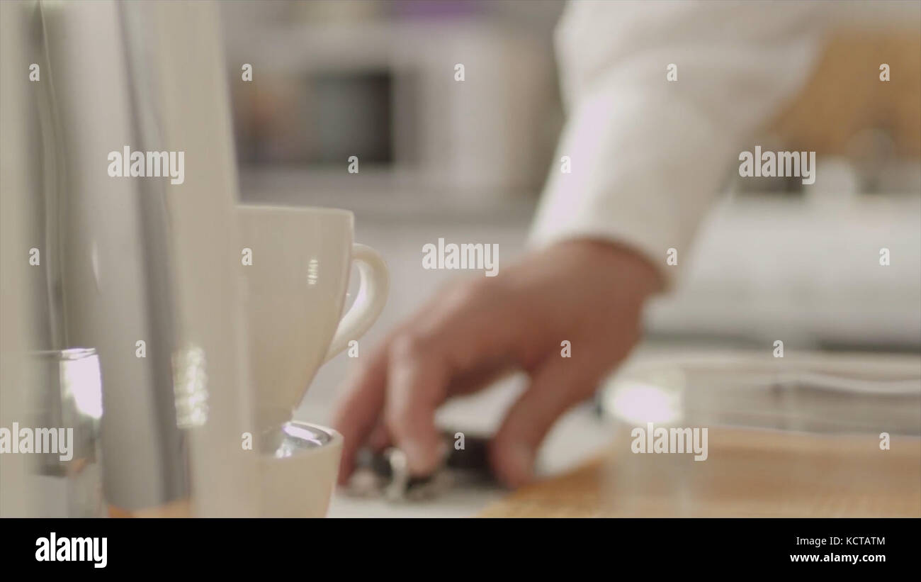 Man put the keys and takes a cup of coffee. Human hands holding a cup ...