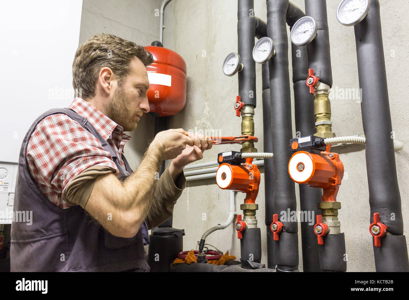plumber at work installing a circulation pump Stock Photo - Alamy