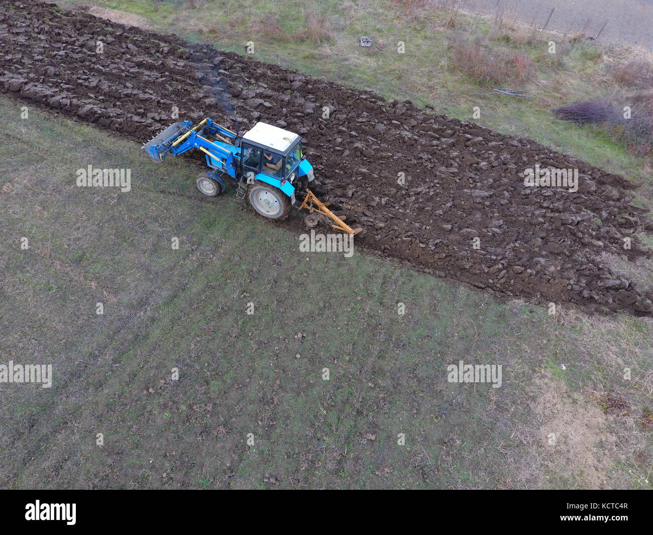 Tractor plowing the garden. Plowing the soil in the garden Stock Photo ...
