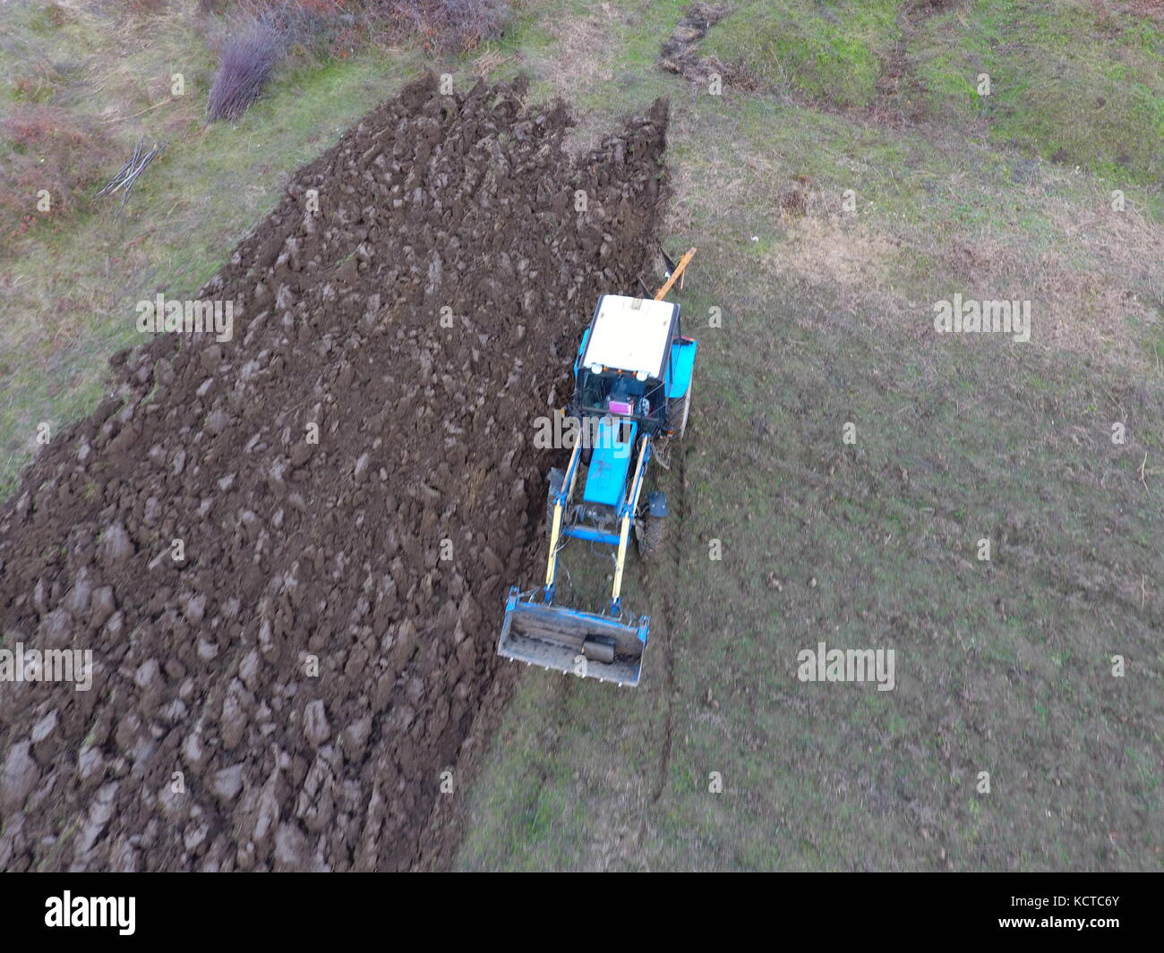 Tractor plowing the garden. Plowing the soil in the garden Stock Photo ...
