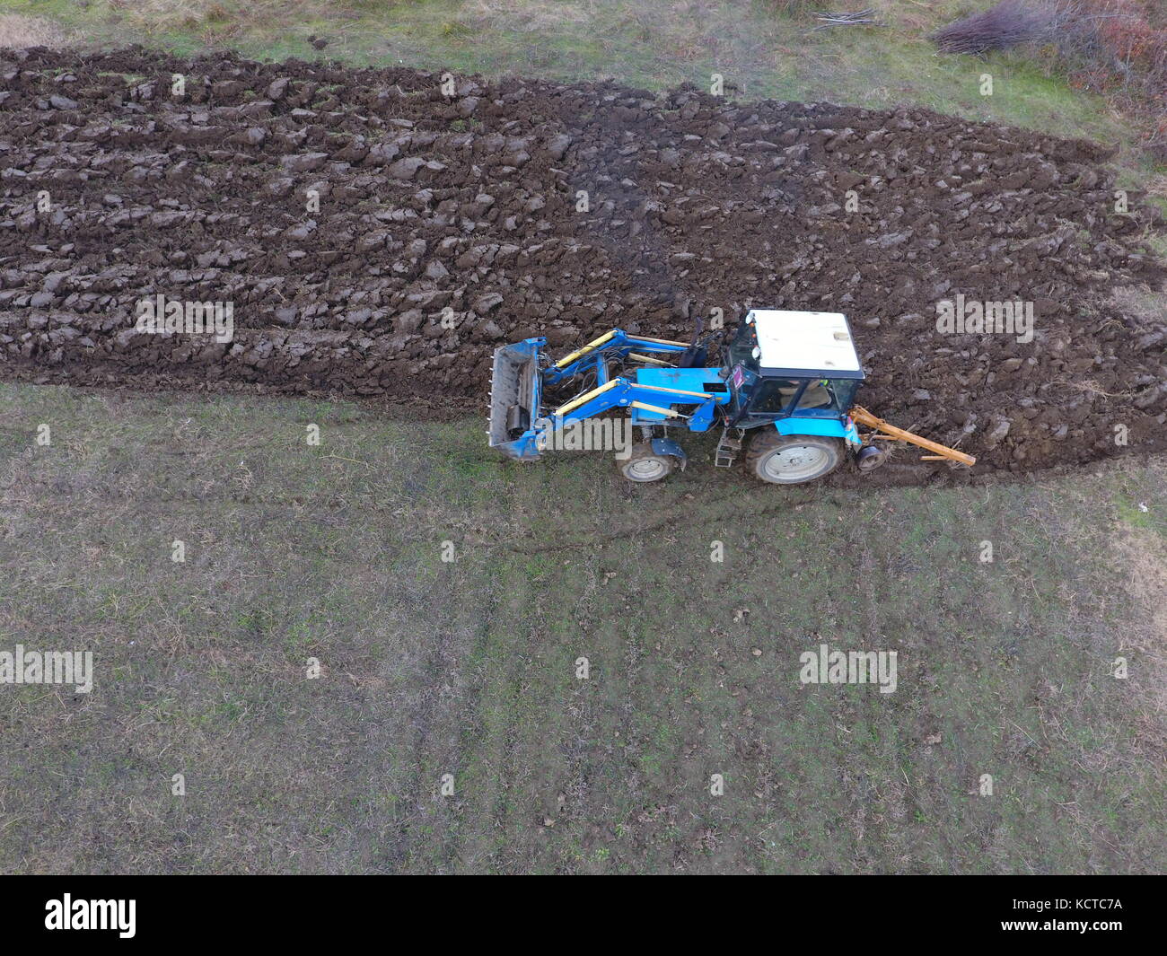 Tractor plowing the garden. Plowing the soil in the garden Stock Photo ...