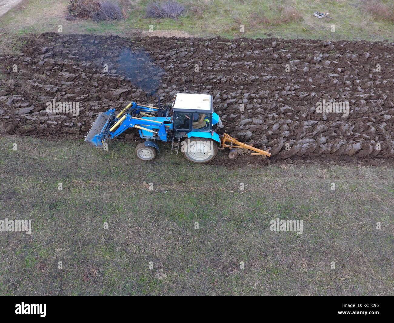 Tractor plowing the garden. Plowing the soil in the garden Stock Photo ...