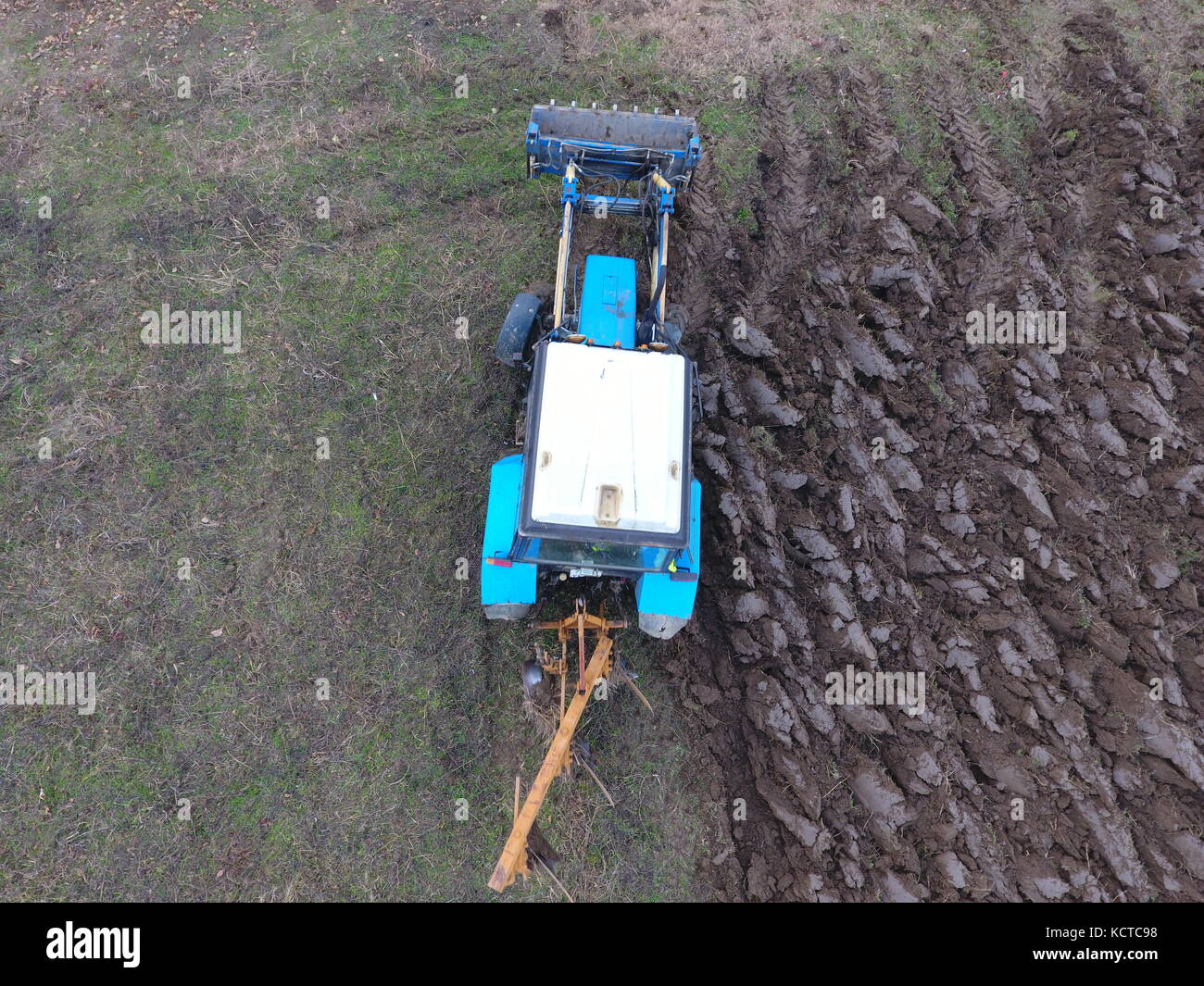 Tractor plowing the garden. Plowing the soil in the garden Stock Photo ...