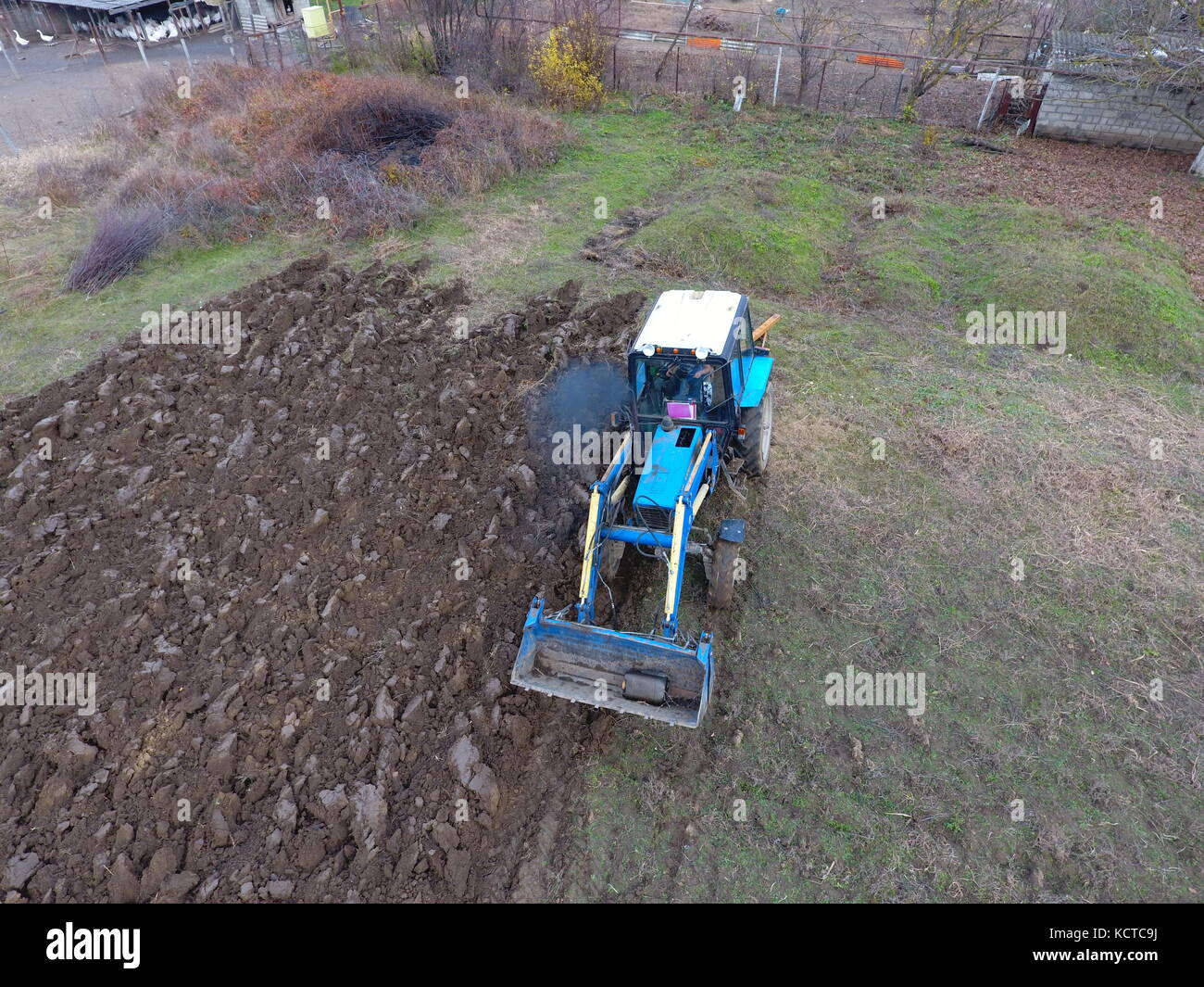 Tractor plowing the garden. Plowing the soil in the garden Stock Photo ...