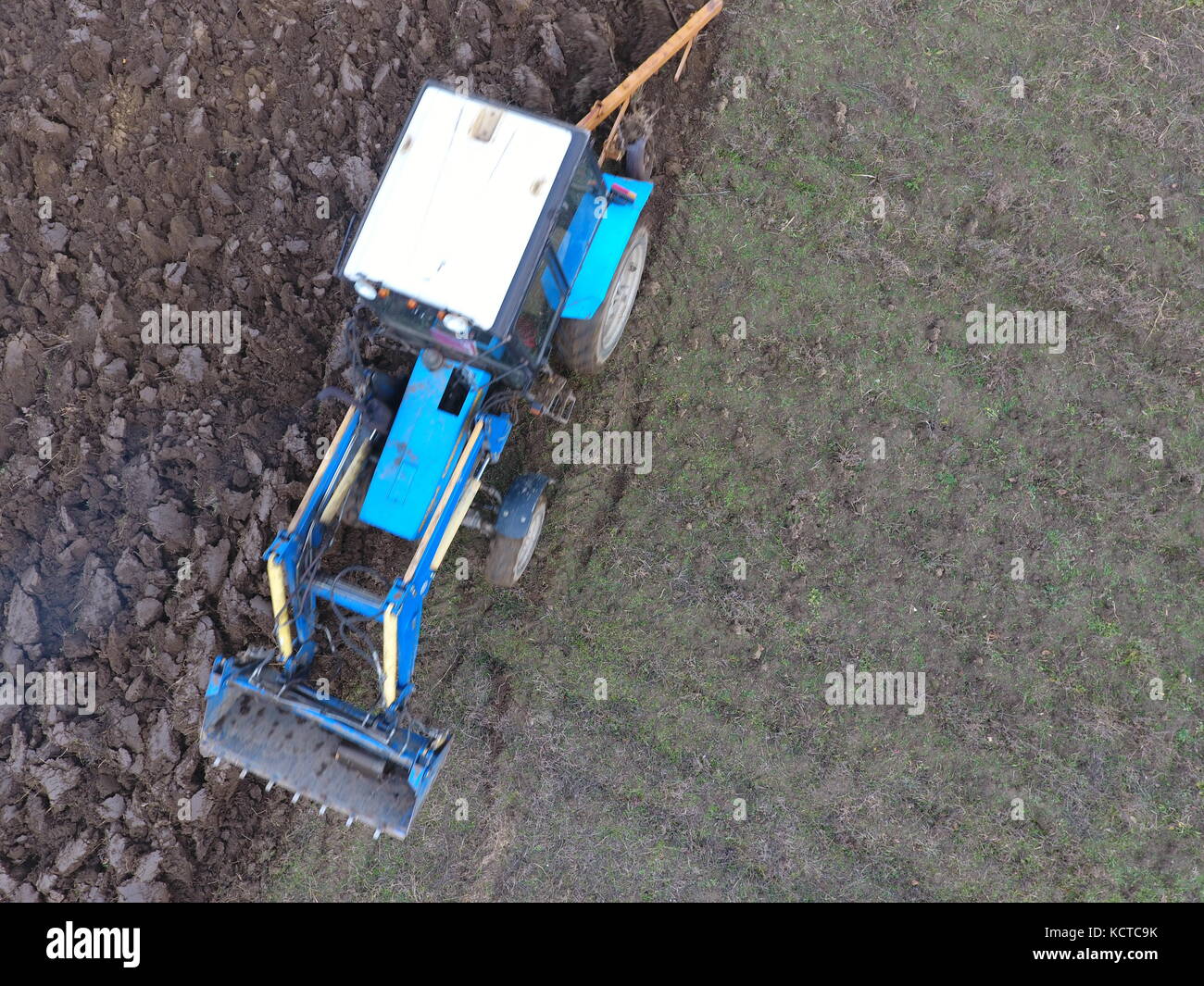 Tractor plowing the garden. Plowing the soil in the garden Stock Photo ...
