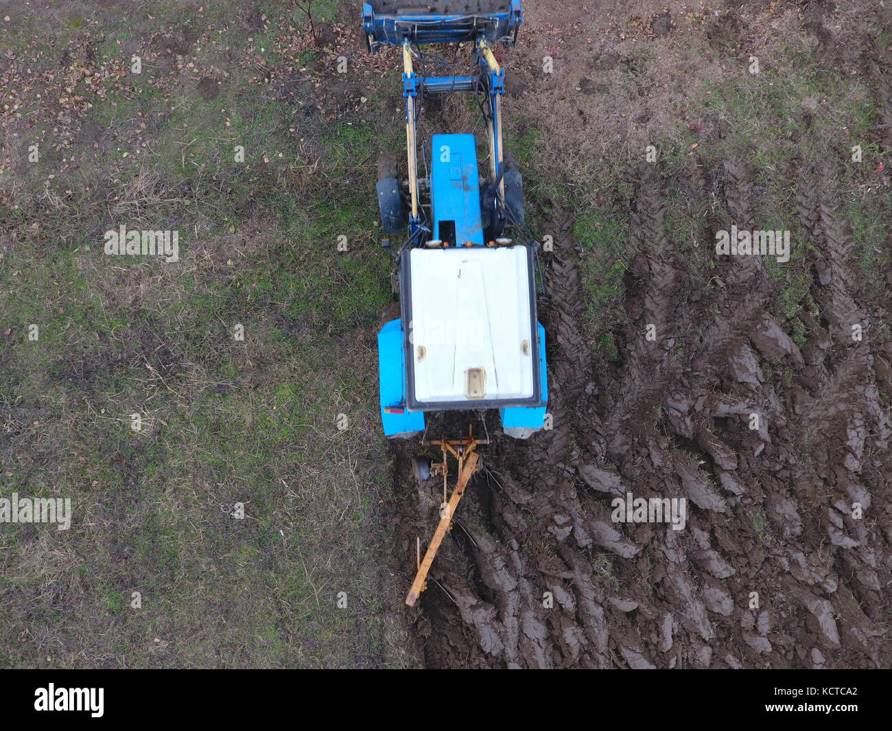 Tractor plowing the garden. Plowing the soil in the garden Stock Photo ...