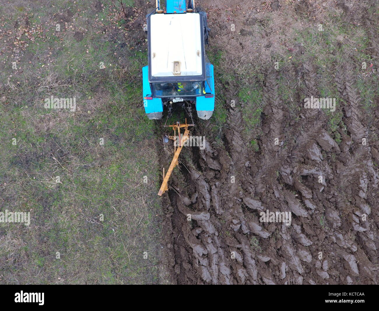 Tractor plowing the garden. Plowing the soil in the garden Stock Photo ...