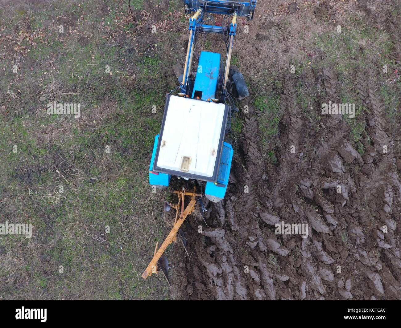 Tractor plowing the garden. Plowing the soil in the garden Stock Photo ...