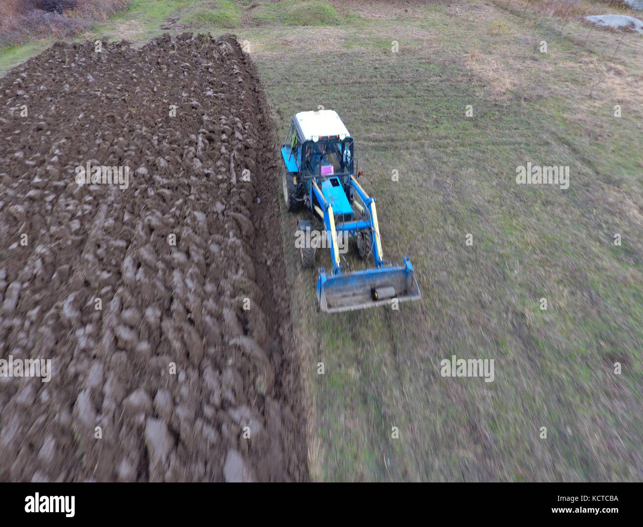 Tractor plowing the garden. Plowing the soil in the garden Stock Photo ...
