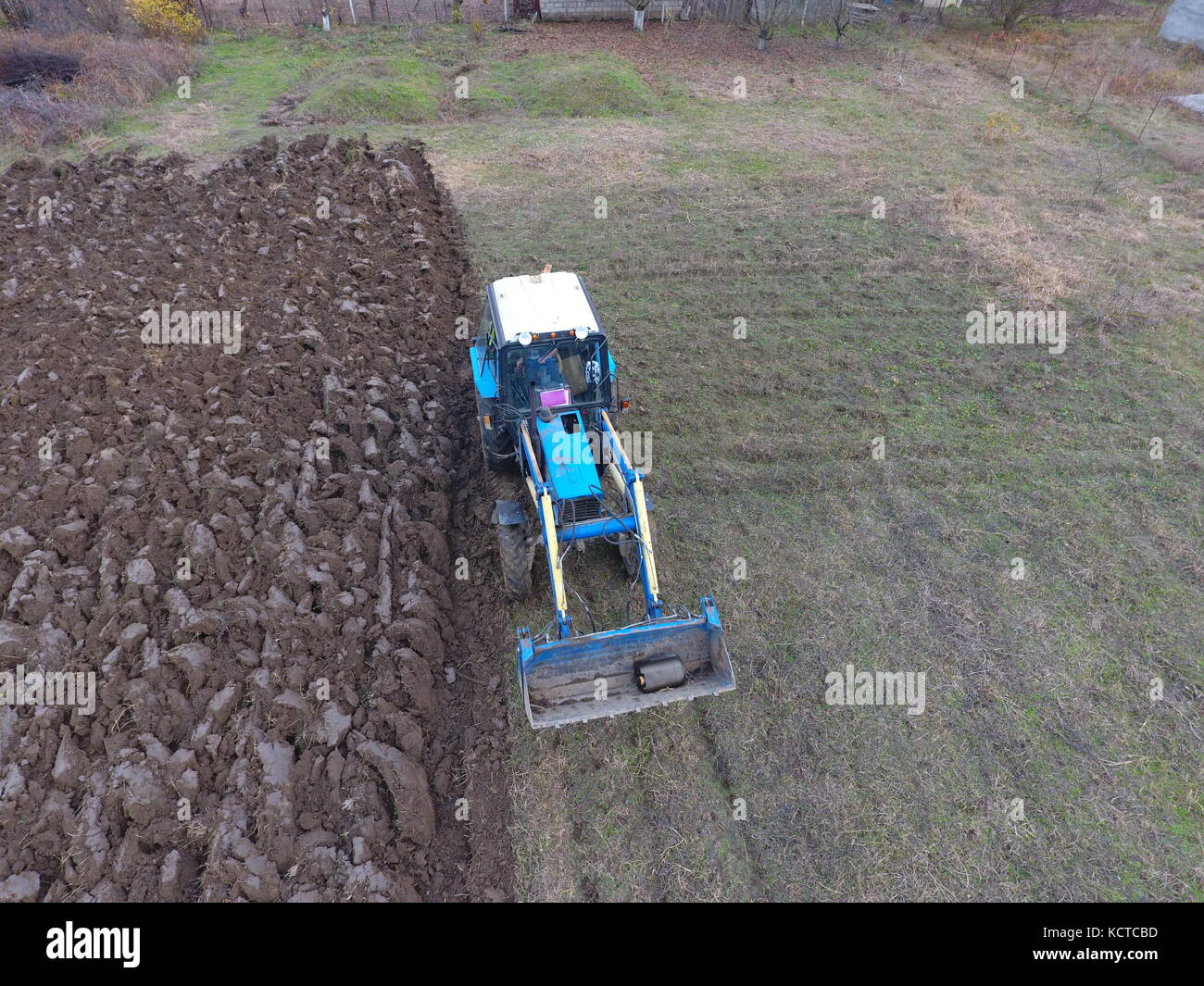 Tractor plowing the garden. Plowing the soil in the garden Stock Photo ...