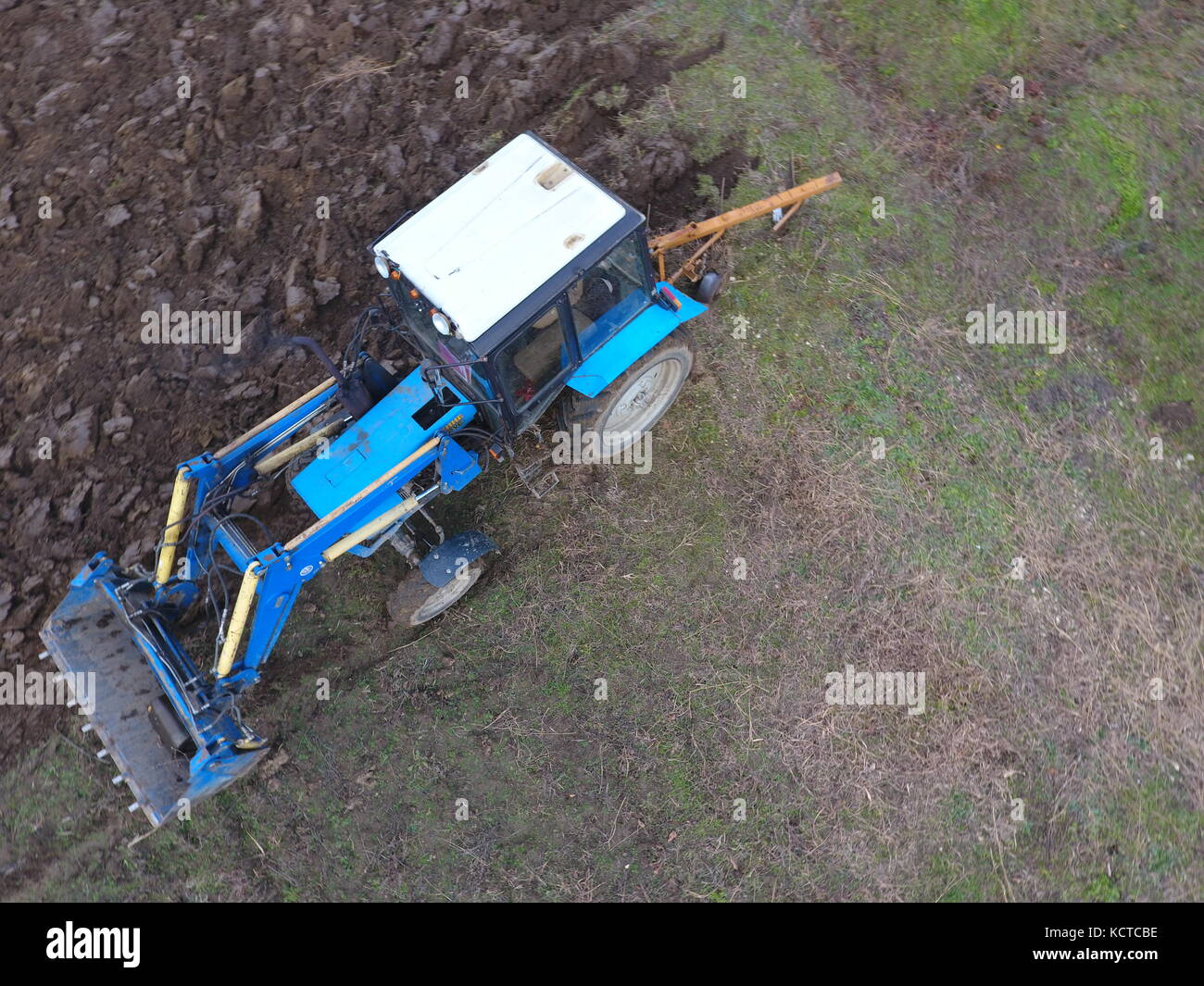Tractor plowing the garden. Plowing the soil in the garden Stock Photo ...
