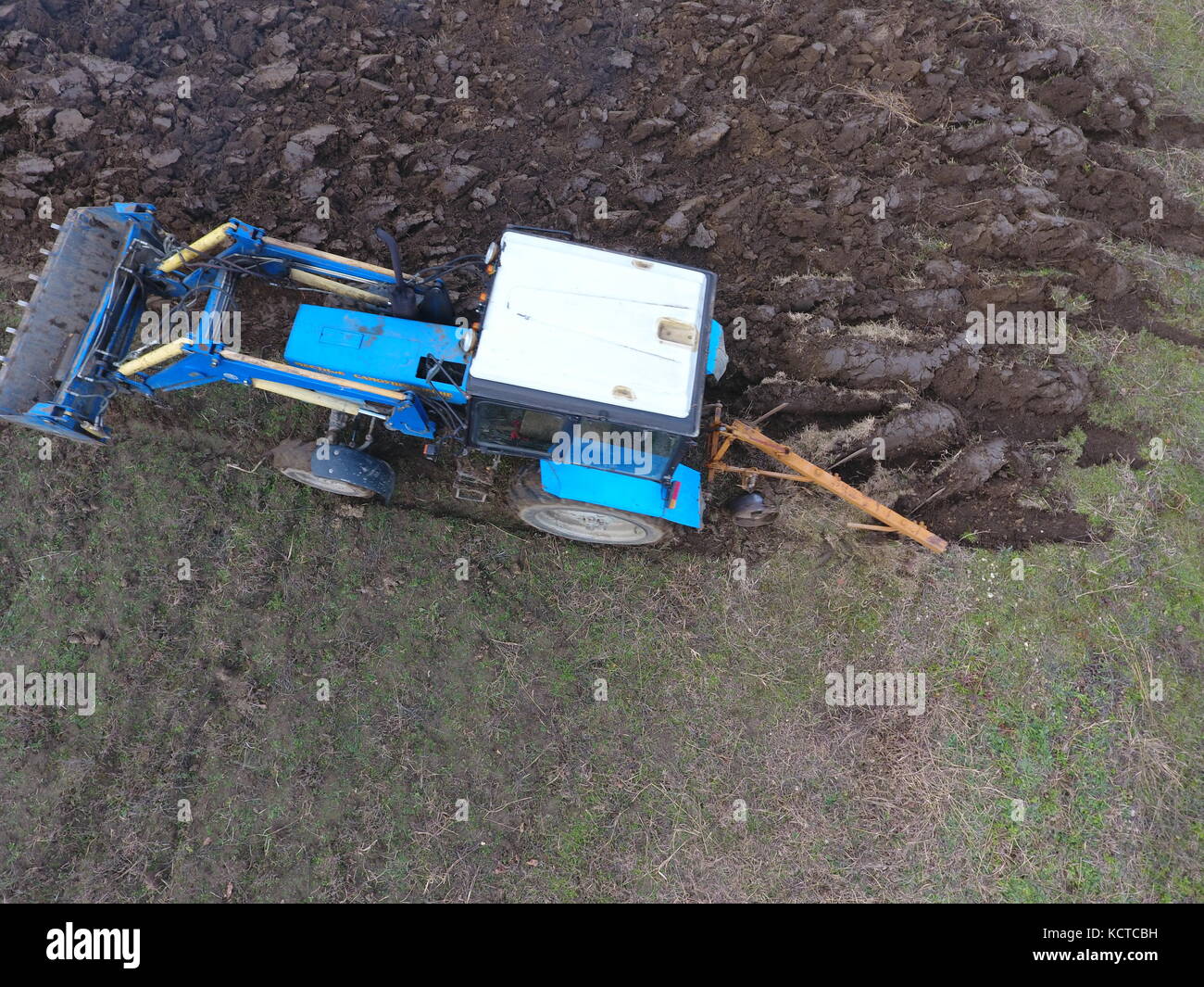 Tractor plowing the garden. Plowing the soil in the garden Stock Photo ...