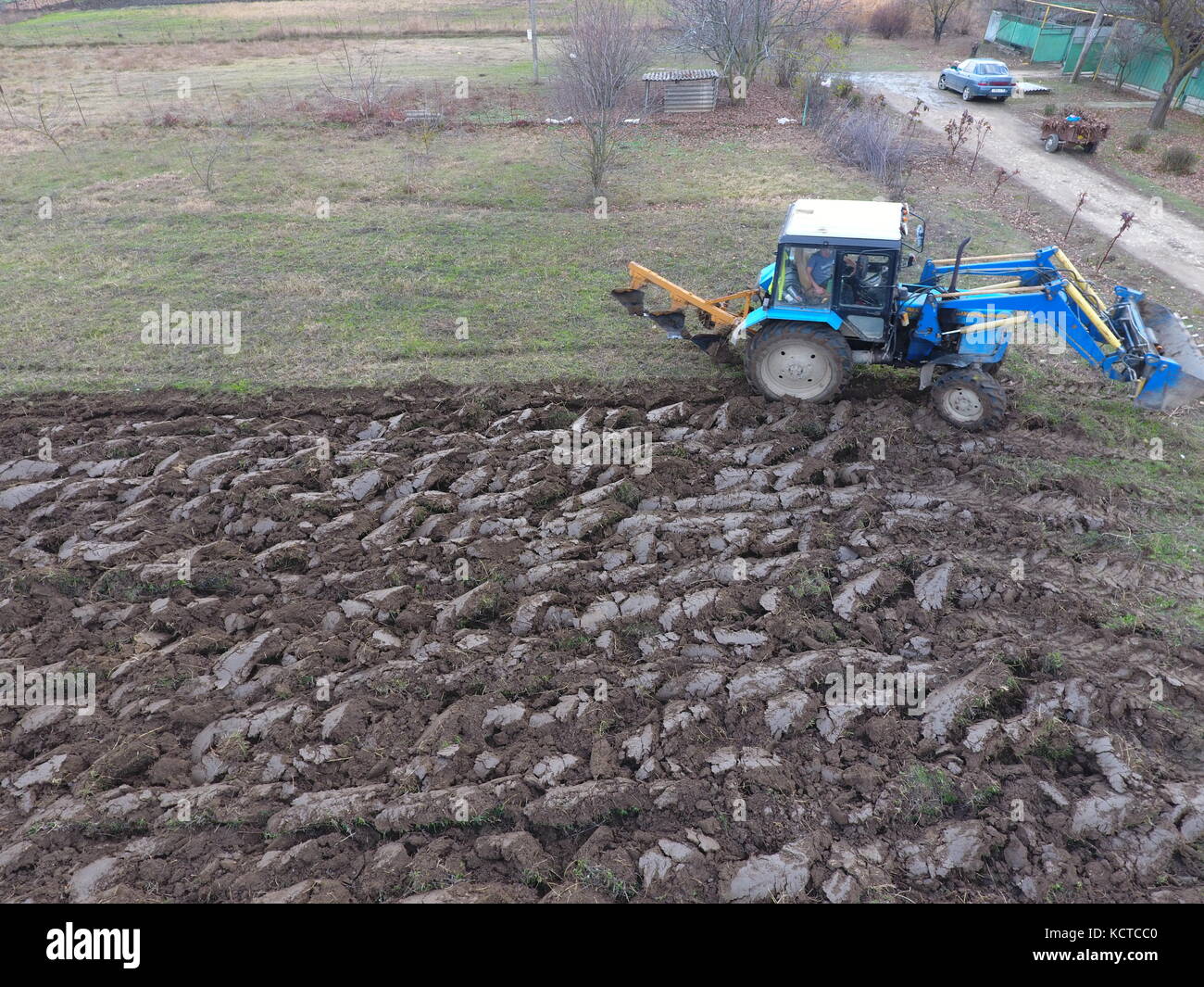 Tractor plowing the garden. Plowing the soil in the garden Stock Photo ...
