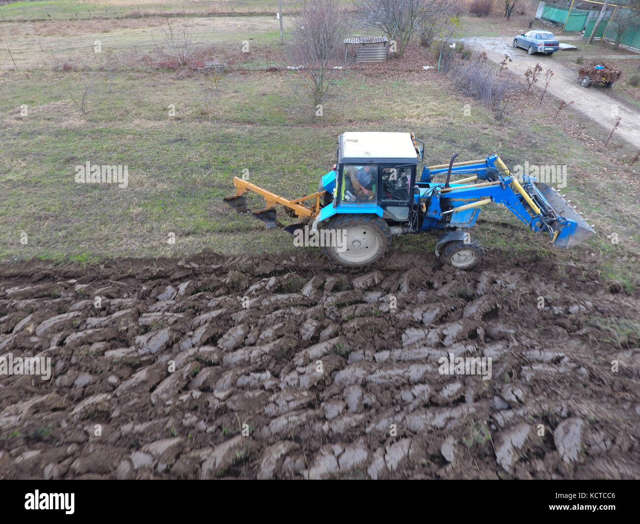 Tractor plowing the garden. Plowing the soil in the garden Stock Photo ...