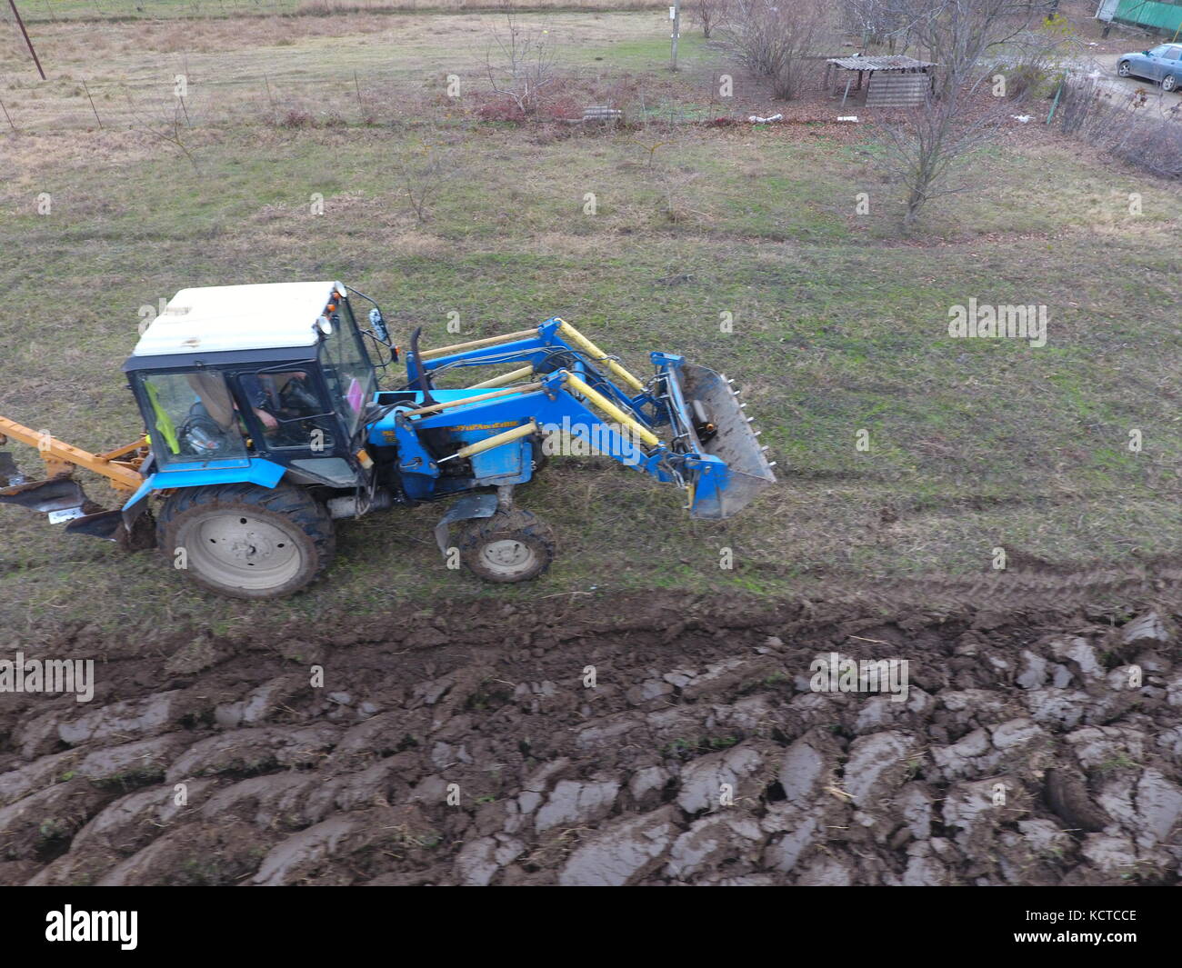 Tractor plowing the garden. Plowing the soil in the garden Stock Photo ...