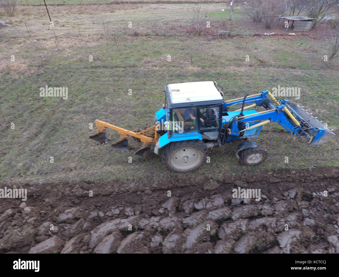 Tractor plowing the garden. Plowing the soil in the garden Stock Photo ...