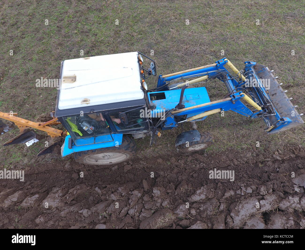 Tractor plowing the garden. Plowing the soil in the garden Stock Photo ...