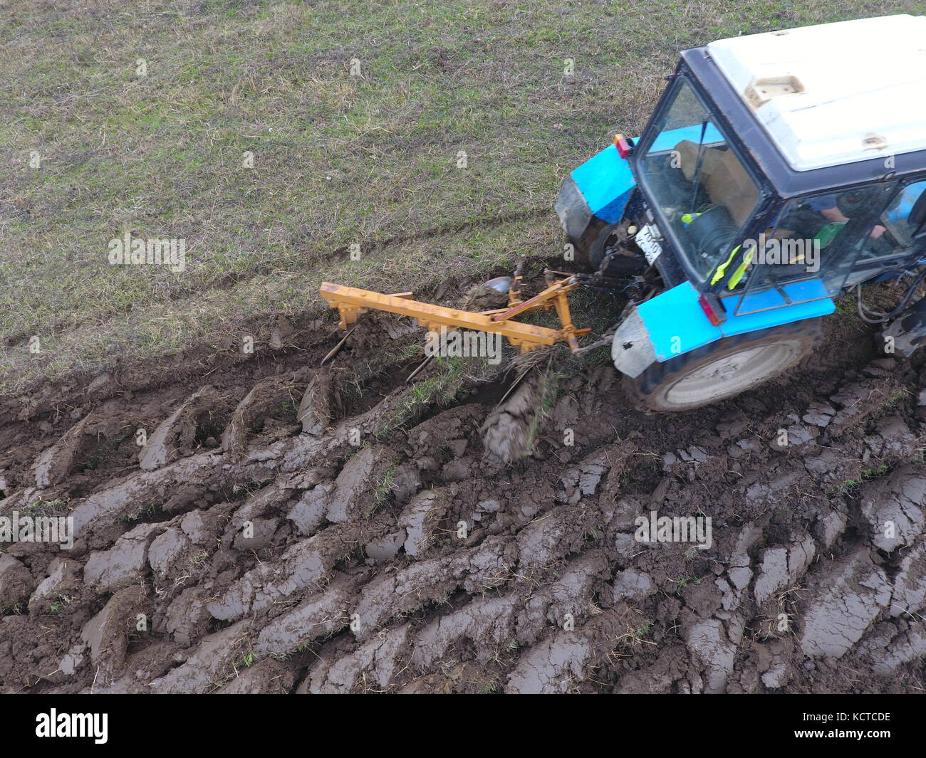 Tractor plowing the garden. Plowing the soil in the garden Stock Photo ...