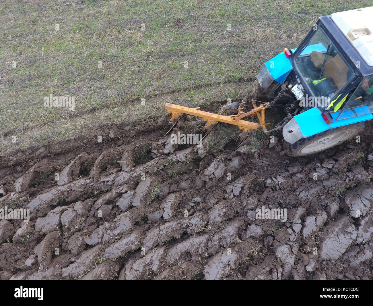 Tractor plowing the garden. Plowing the soil in the garden Stock Photo ...
