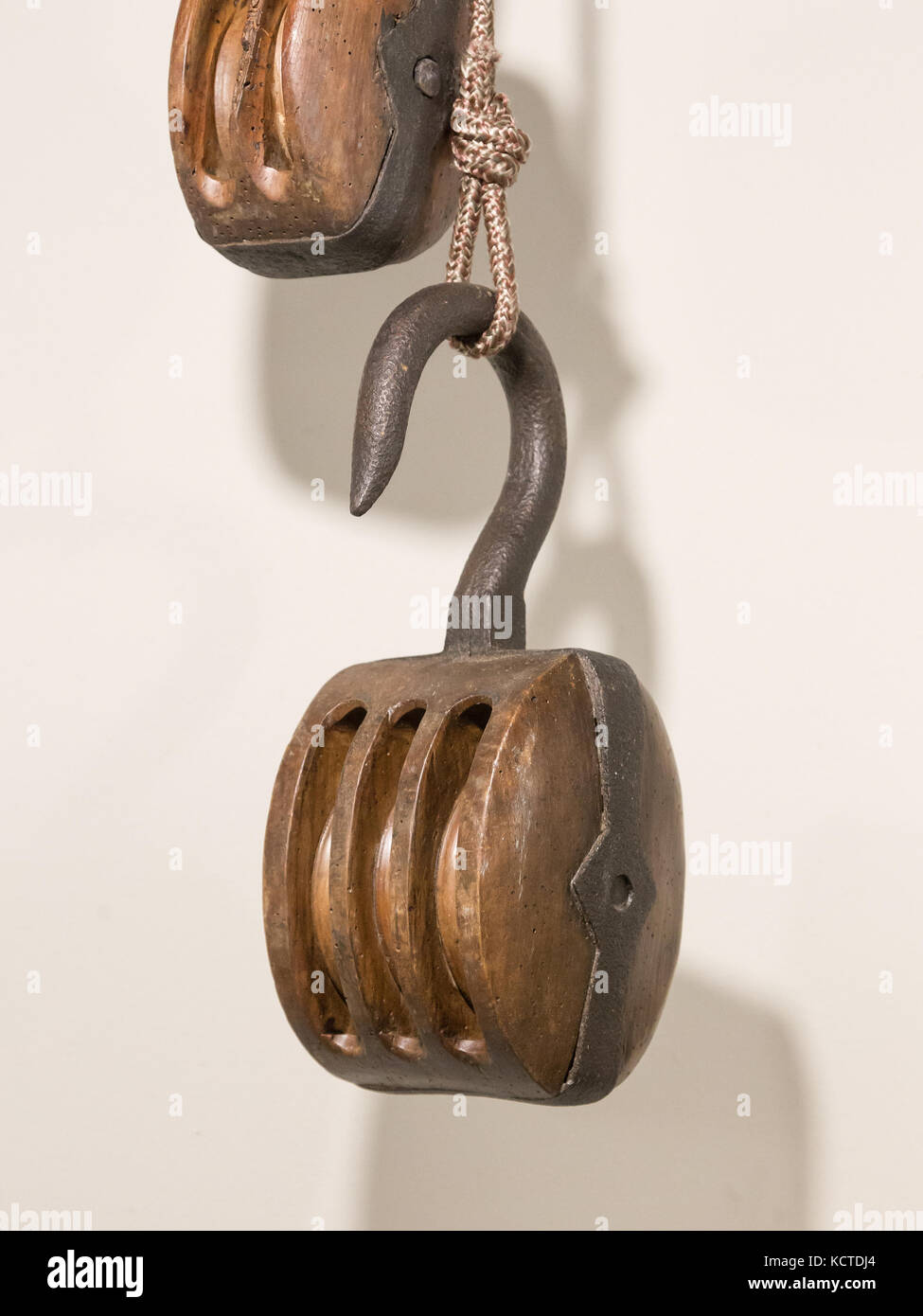 Old wooden pulley, isolated on a white wall Stock Photo - Alamy