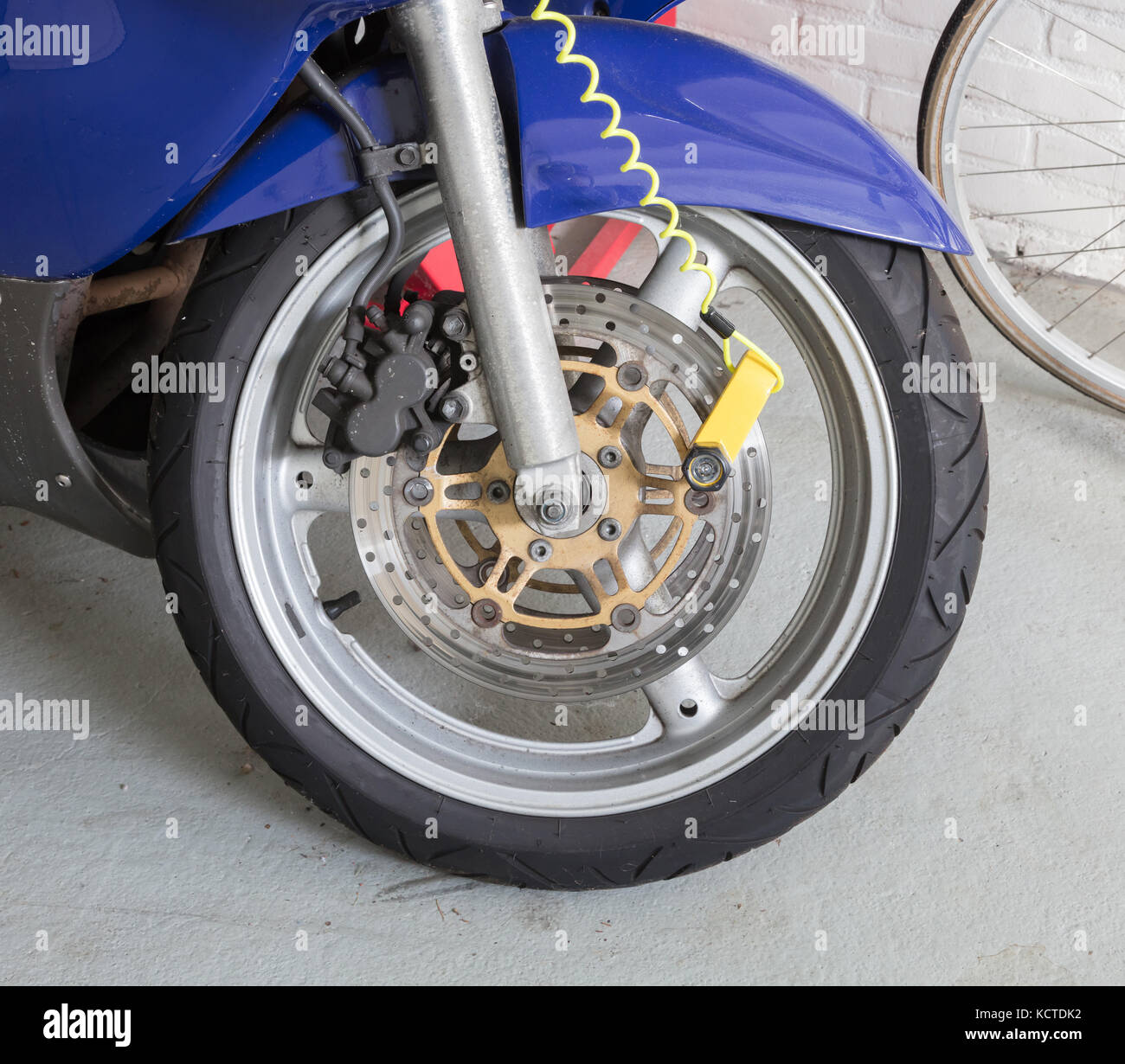 Security lock blocking the motorcycle front wheel - Selective focus ...