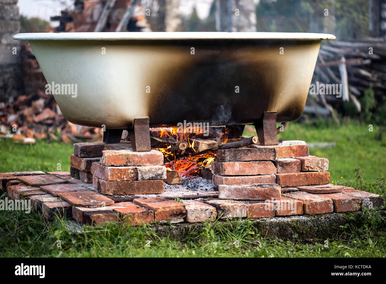 Improvised hot bathtub with fire underneath Stock Photo - Alamy