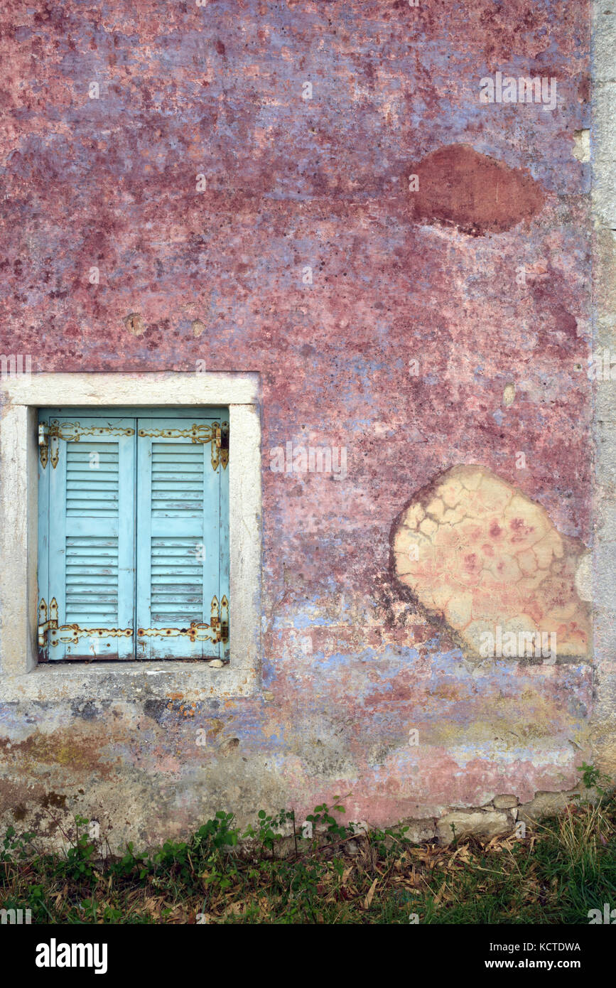 an old greek building in a poor state of repair with peeling green and ...