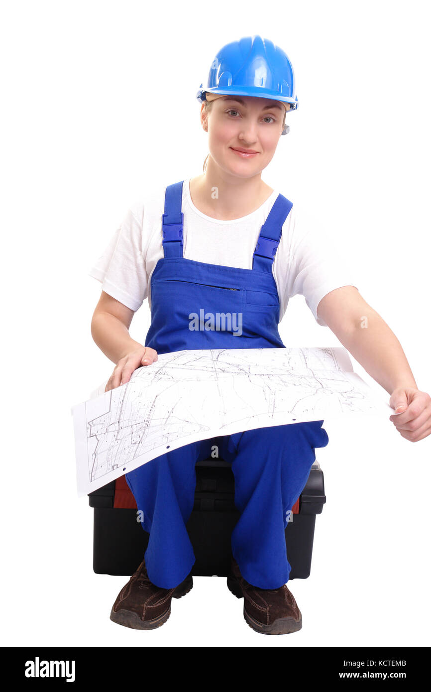 Female civil engineer wearing blue helmet and jumpsuit studying ...
