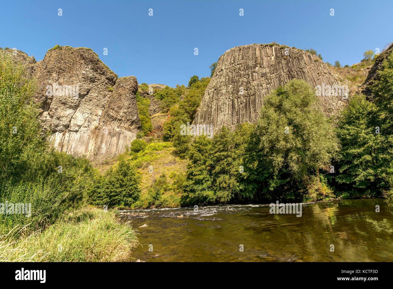 Prades village. The volcanic basalt formation of Roche Serviere. Haute ...