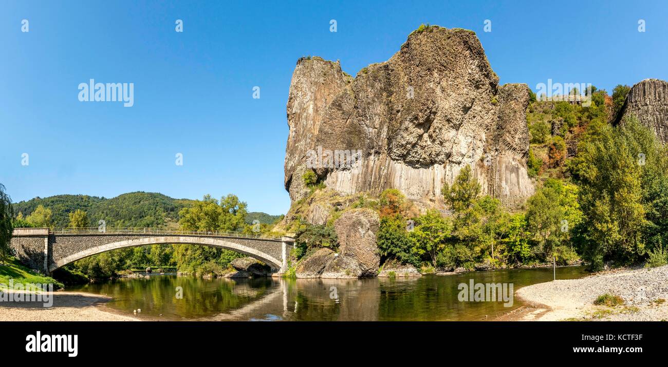 Prades village. The volcanic basalt formation of Roche Serviere. Haute ...