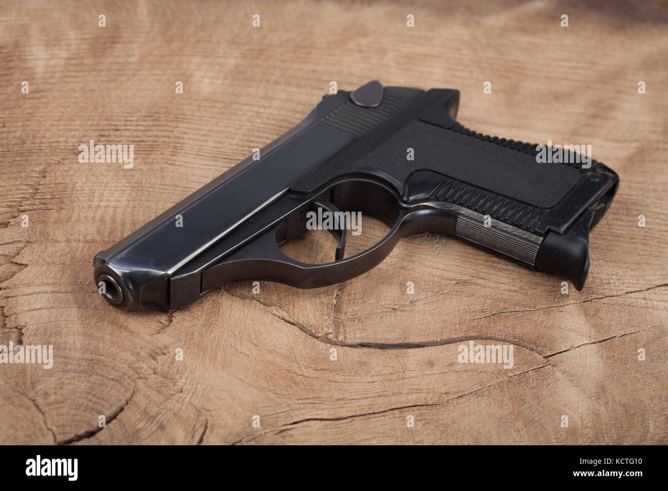 handgun with ammunition on the wooden table Stock Photo - Alamy