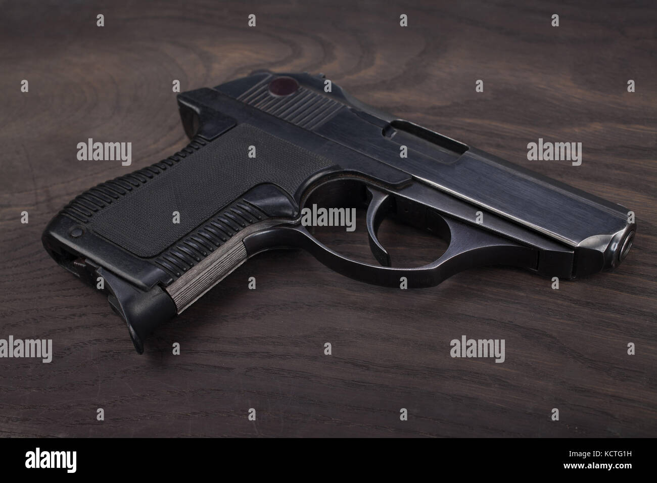 handgun on the wooden table Stock Photo - Alamy
