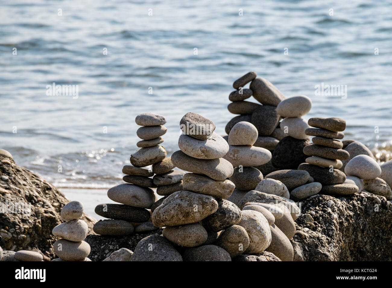 Close-Up Of Balanced Stones Stacked On Rock Near Beach And Ionian Sea ...