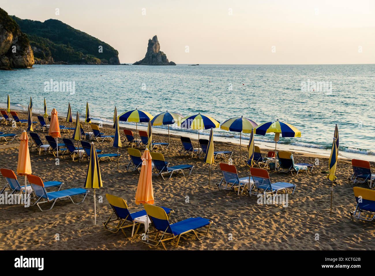 Umbrellas And Closed Parasols At Beach Next To Ionian Sea During Sunset ...