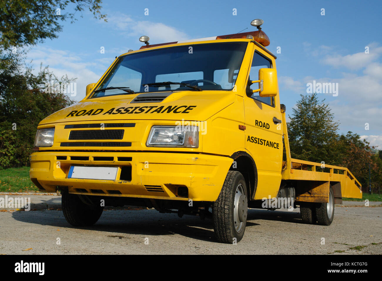 Yellow road assistance vehicle parked Stock Photo - Alamy