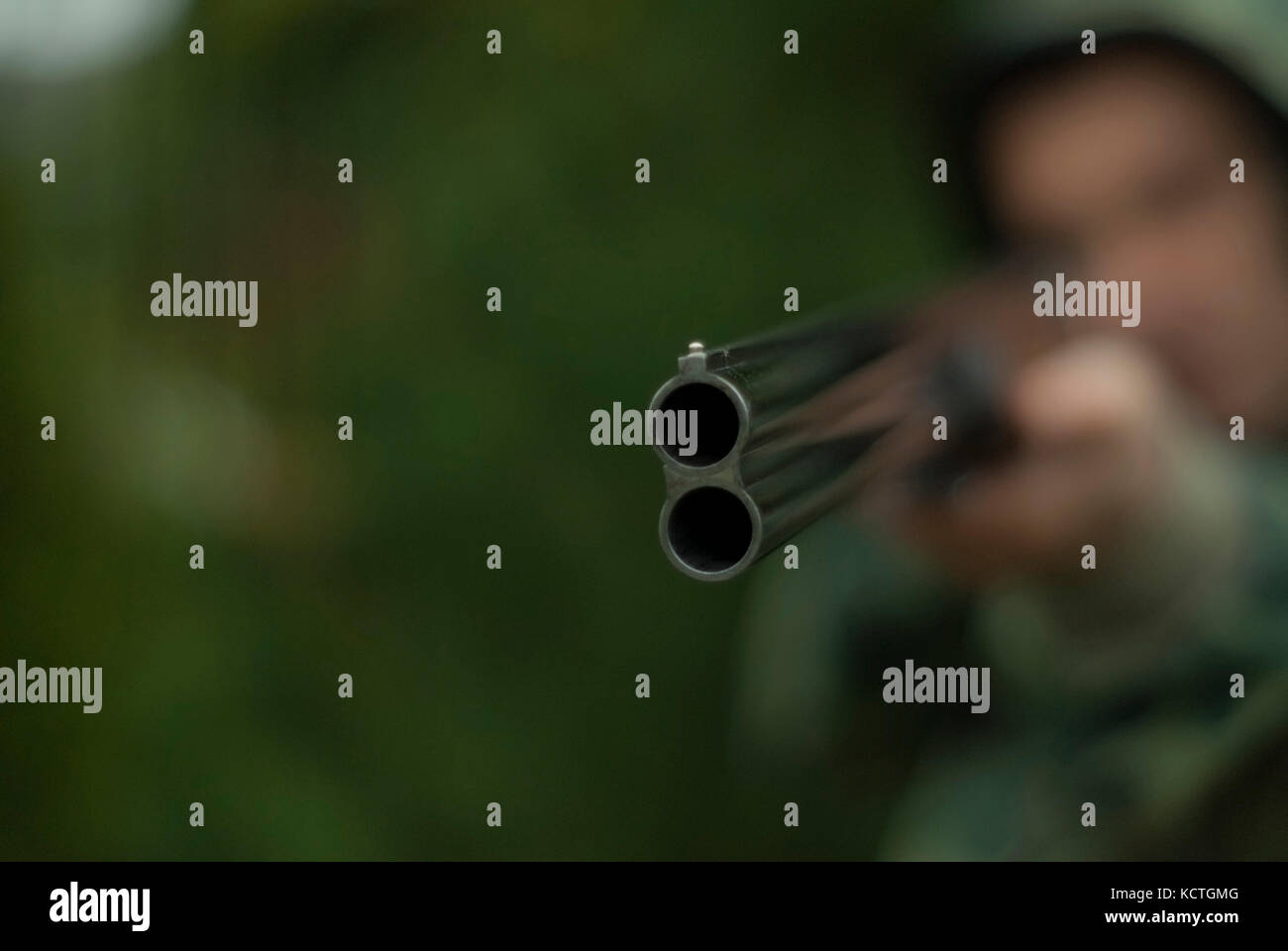 The double-barreled (over/under) hunting rifle in the hands of the ...