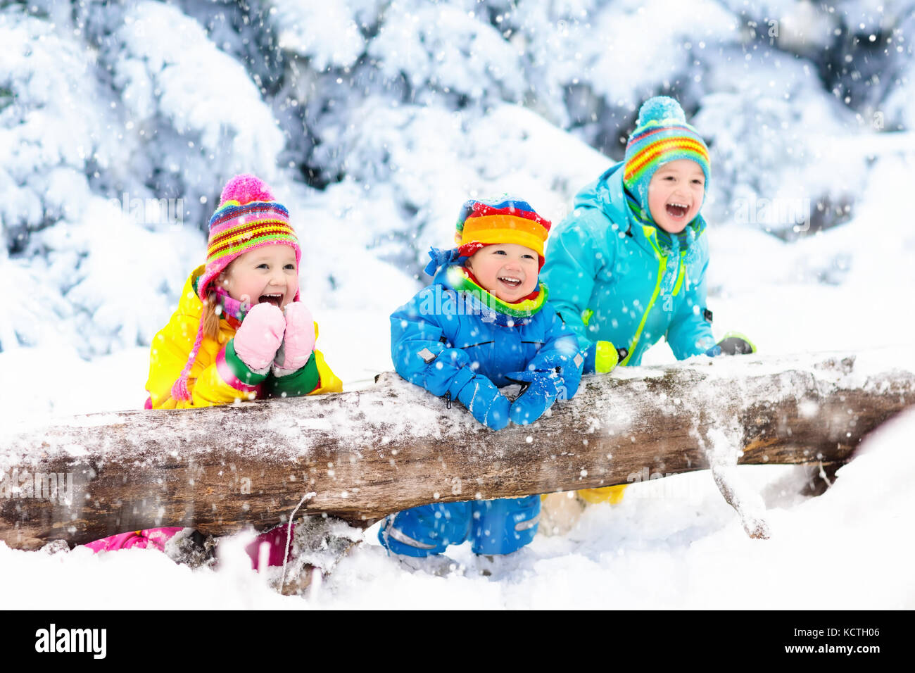Kids playing in snow. Children play outdoors on snowy winter day. Boy ...