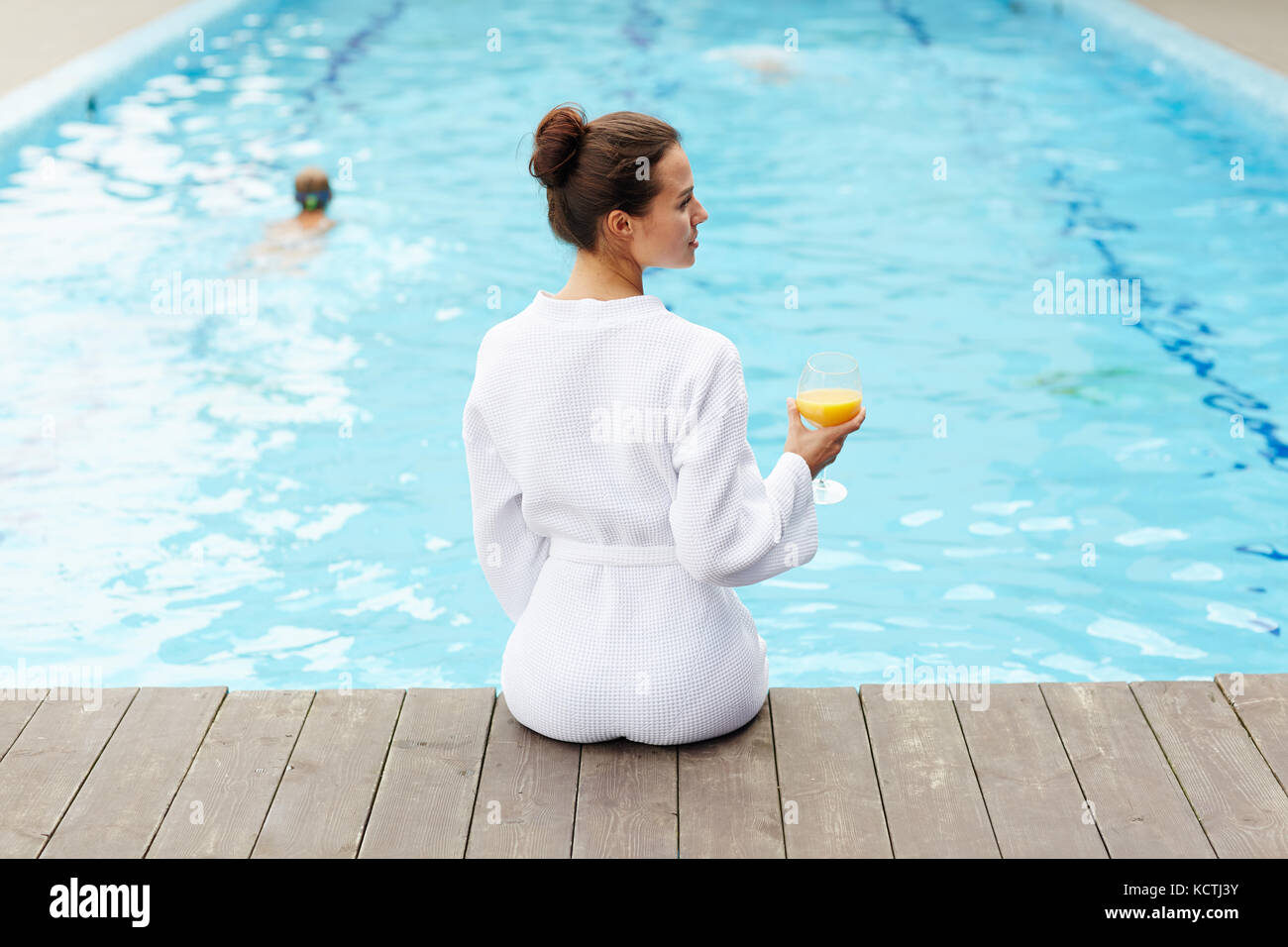 Relaxing by swimming-pool Stock Photo - Alamy