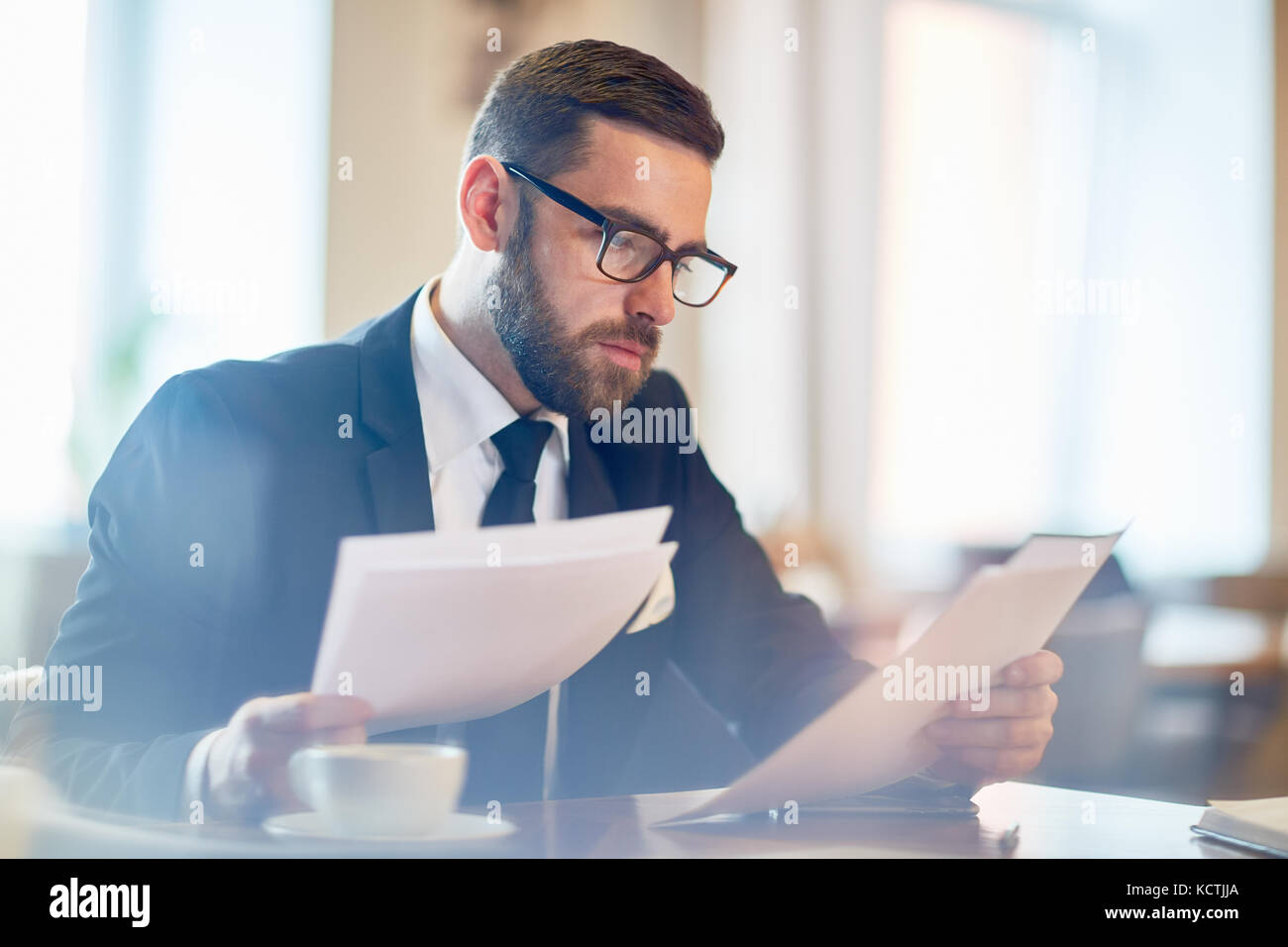 Looking through papers Stock Photo - Alamy